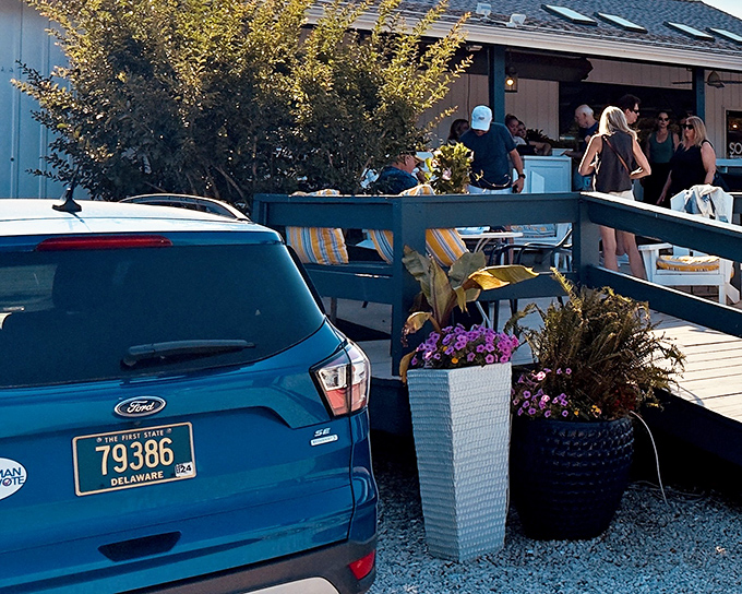 The welcoming entrance to Bluecoast beckons with coastal charm, where Delaware license plates mingle with out-of-state visitors seeking seafood nirvana.