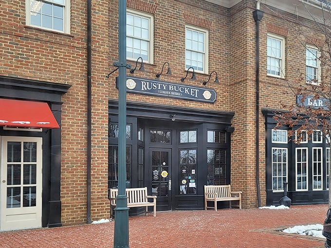 The warm brick exterior of Rusty Bucket welcomes you like an old friend who's genuinely happy to see you. Those benches practically whisper, "Come on in, the comfort food's fine."