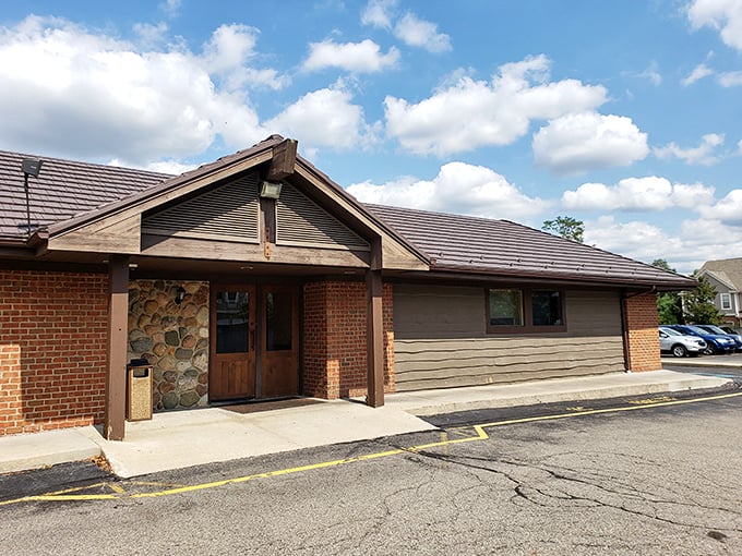 The rustic stone and timber exterior of Alibi of Troy beckons like a cozy northern Michigan lodge that somehow landed in the suburbs.