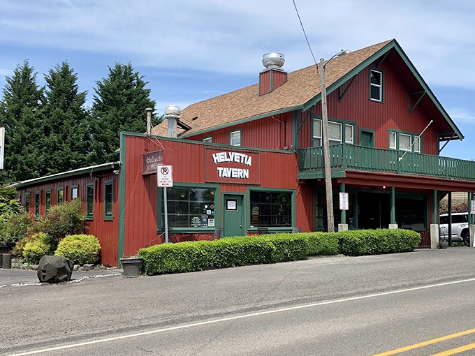 The iconic red exterior of Helvetia Tavern stands like a culinary lighthouse in rural Hillsboro, beckoning hungry travelers with promises of burger perfection.