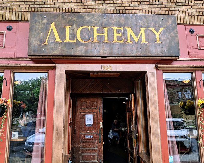 The pink facade and weathered "ALCHEMY" sign aren't trying to impress anyone&mdash;they're too busy promising authentic flavors that will do all the talking necessary.