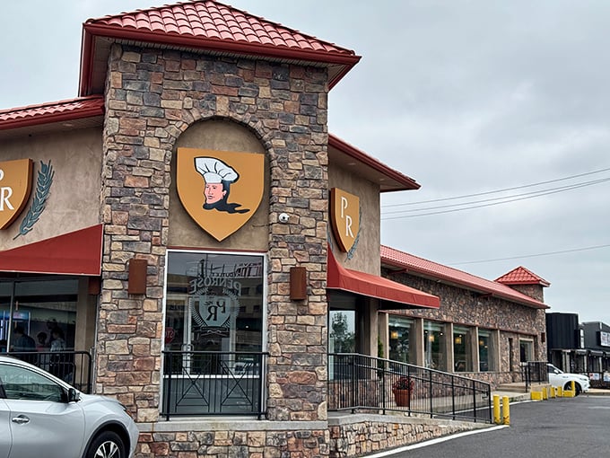 The stone facade and iconic "PR" shield logo of Penrose Diner stands as a beacon of breakfast hope on Penrose Avenue, promising comfort food salvation inside.
