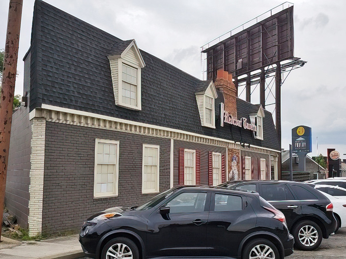 Colonial charm meets Midwest hospitality at Redcoat Tavern's distinctive exterior. That red door isn't just an entrance&mdash;it's a portal to culinary bliss. 