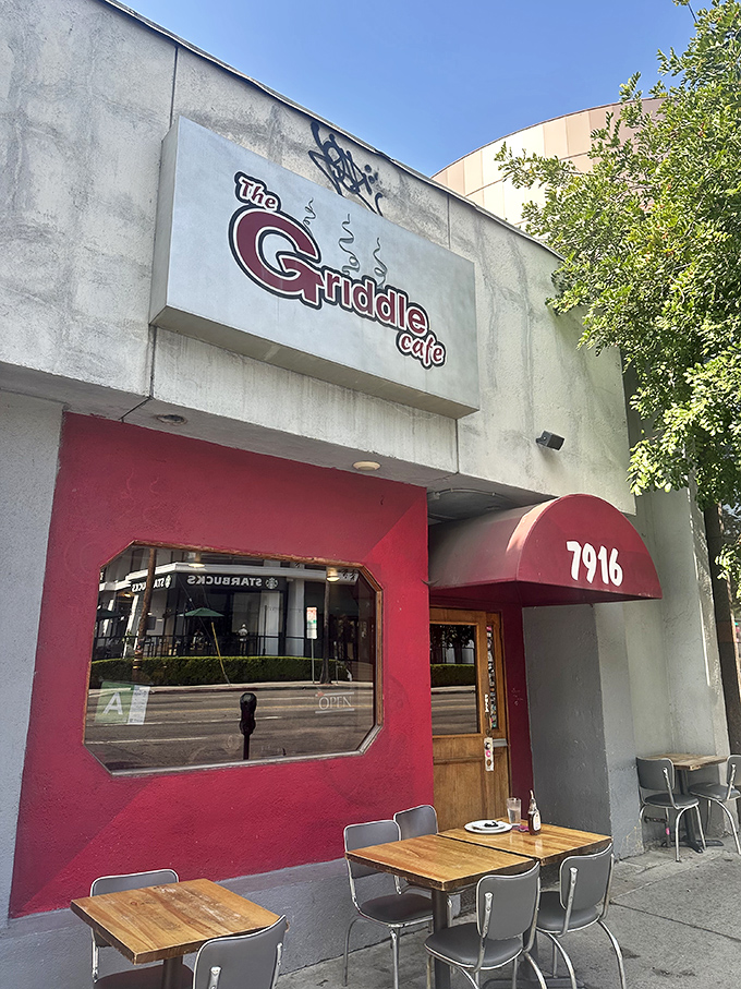 The bright red exterior of The Griddle Cafe beckons like a breakfast beacon on Sunset Boulevard, promising sweet salvation for hungry souls.