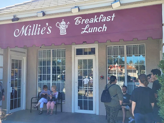 Millie's burgundy awning beckons like a breakfast lighthouse, guiding hungry souls to a harbor of pancakes and possibilities.