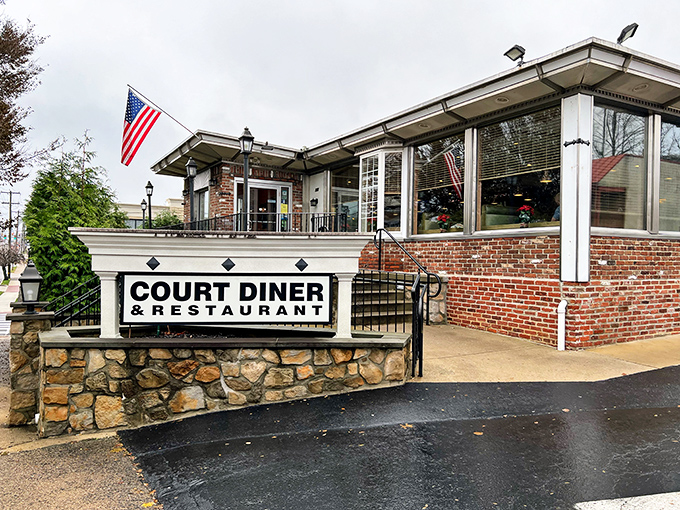 The classic brick and stone exterior of Court Diner stands proudly in Media, complete with American flag – a beacon of breakfast hope for hungry Pennsylvanians.