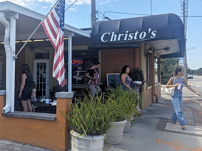 The bright red exterior of Christo's Cafe stands out like a culinary beacon in Orlando, promising comfort food that transcends ordinary diner fare.