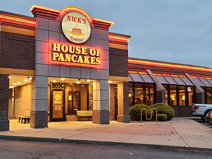 The iconic red and yellow sign of Nick's Original House of Pancakes stands like a breakfast lighthouse, guiding hungry souls to pancake paradise.
