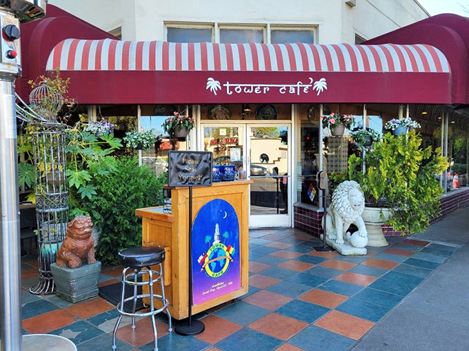 Welcome to flavor paradise! Tower Caf&eacute;'s vibrant exterior with its distinctive red awning and lush greenery promises an escape from ordinary breakfast experiences.