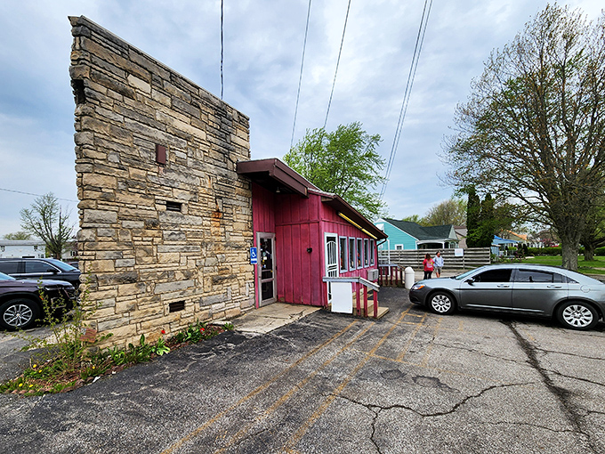 The stone facade and bright red exterior of Porky's stands like a culinary time capsule, preserving flavors that chain restaurants can only dream of replicating.