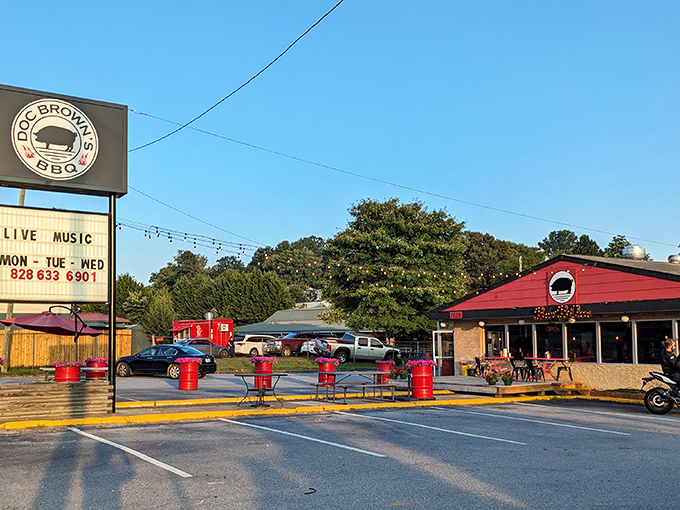 The crimson exterior of Doc Brown's BBQ stands like a beacon of hope for hungry travelers, complete with their iconic pig silhouette promising smoky delights within.
