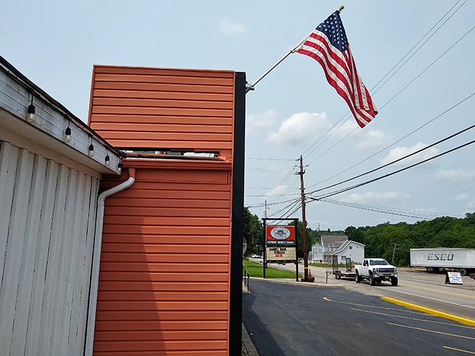The American flag waves proudly outside this unassuming BBQ joint, like a beacon calling hungry travelers home. Small in stature, mighty in flavor.