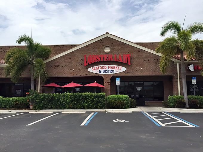 The glowing red sign of Lobster Lady beckons seafood lovers like a lighthouse guiding hungry sailors to shore.