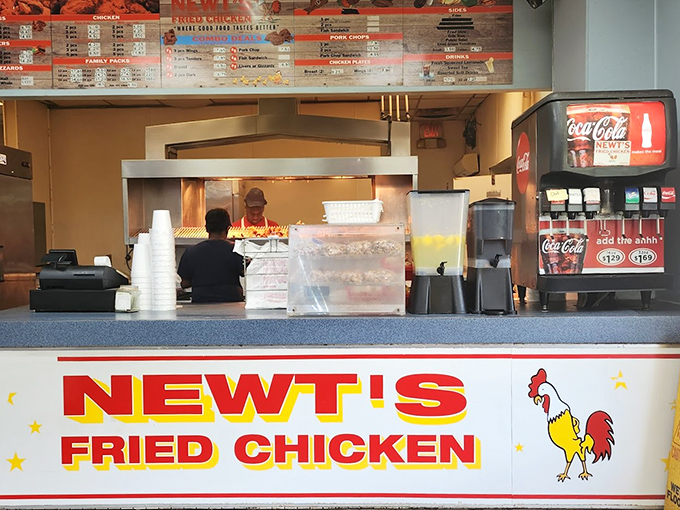 The bright red Newt's Fried Chicken sign promises salvation for the hungry soul. Simple counter service, maximum flavor delivery.
