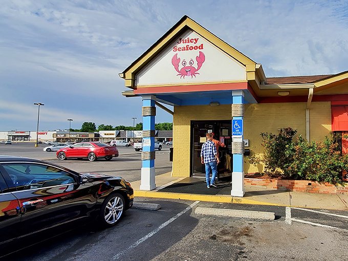 The cheerful yellow facade with its cartoon crab mascot promises seafood salvation in strip mall heaven. No pretension, just delicious possibilities waiting inside.