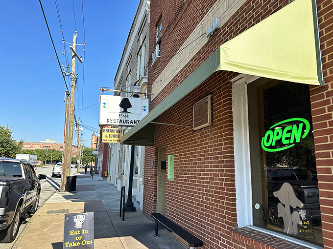 The unassuming brick exterior of H&H Restaurant in Macon hides culinary treasures within, like a Southern speakeasy for the soul-food obsessed.