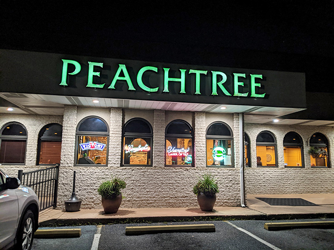 The glowing Peachtree sign beckons hungry travelers like a lighthouse for the gastronomically adrift. No fancy frills, just the promise of serious eating ahead.