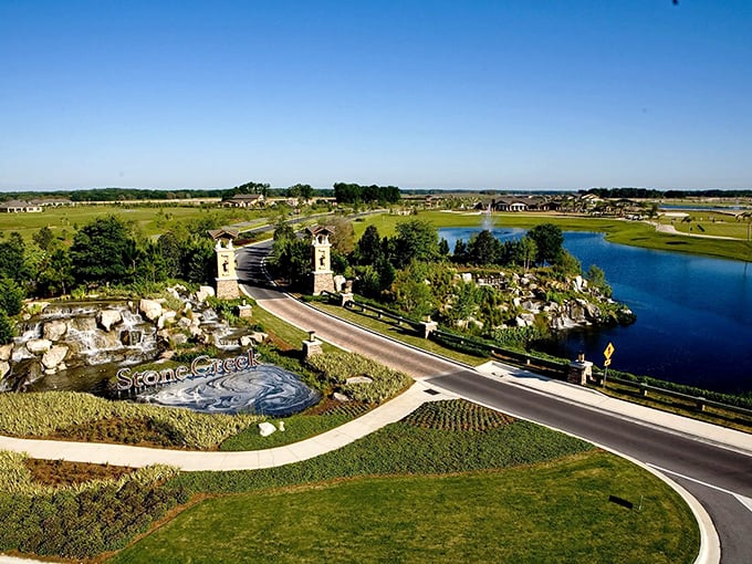 Stone Creek's grand entrance welcomes residents home with cascading waterfalls, serene lakes, and the promise of Florida's good life beyond the gates.