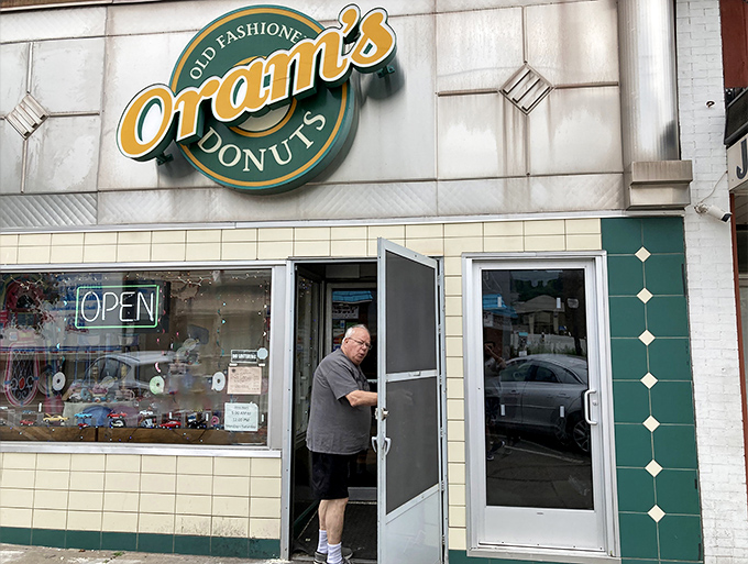 The green and cream facade of Oram's stands like a beacon of sweetness on Beaver Falls' main drag, promising old-fashioned delights within.