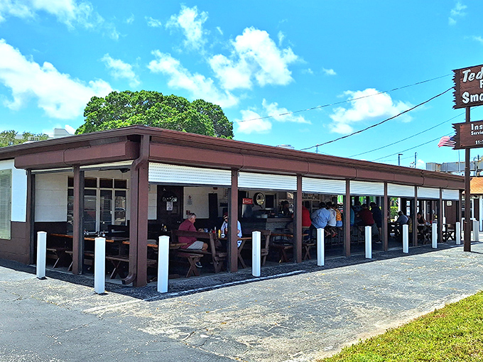 The unassuming brown exterior of Ted Peters might not scream "culinary landmark," but that smoky aroma wafting through the air tells the real story. 