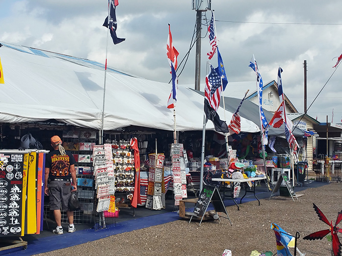 American flags flutter above a sprawling marketplace where RVs and tents create the perfect backdrop for treasure hunting adventures in the Texas sun.
