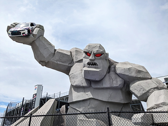 Miles the Monster looms large at night, his glowing red eyes and massive concrete form creating an otherworldly sentinel at Dover Motor Speedway's entrance.