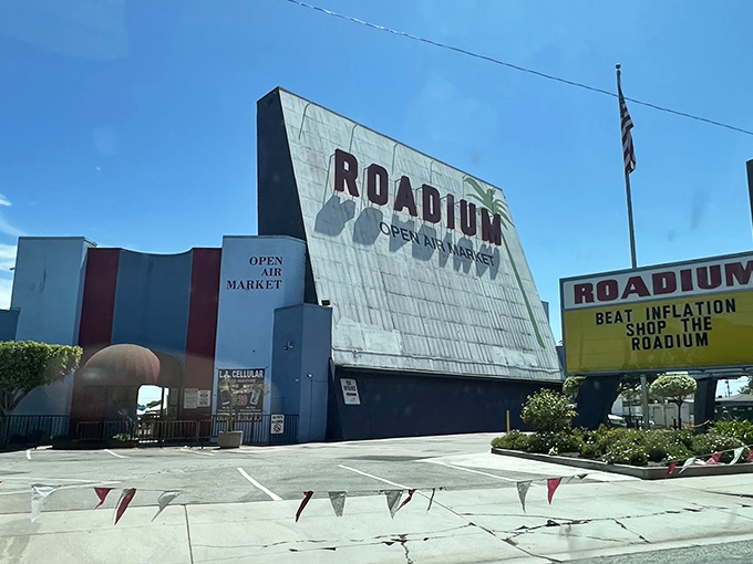 The iconic blue and white facade of The Roadium stands like a retro movie marquee, promising treasures within rather than feature films. 