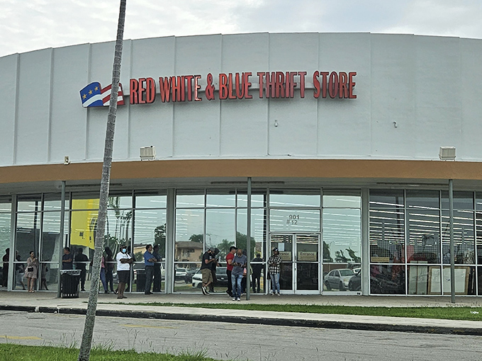 The iconic white exterior of Red White & Blue Thrift Store stands like a retail fortress against the Florida sky, promising treasures within.