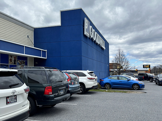 The blue and white facade of Ellicott City's Goodwill stands like a beacon of bargain possibilities, promising treasures within its unassuming exterior.