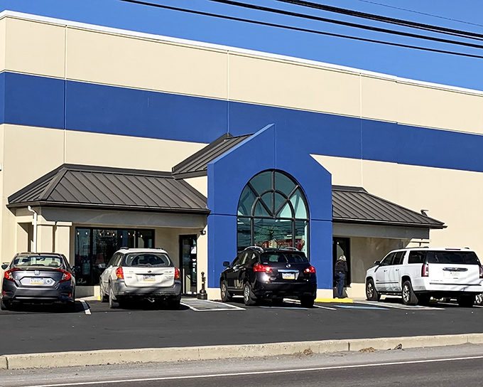 The blue and cream exterior of Re-Uzit Shop stands like a beacon of bargain possibilities, promising treasures within its welcoming doors.