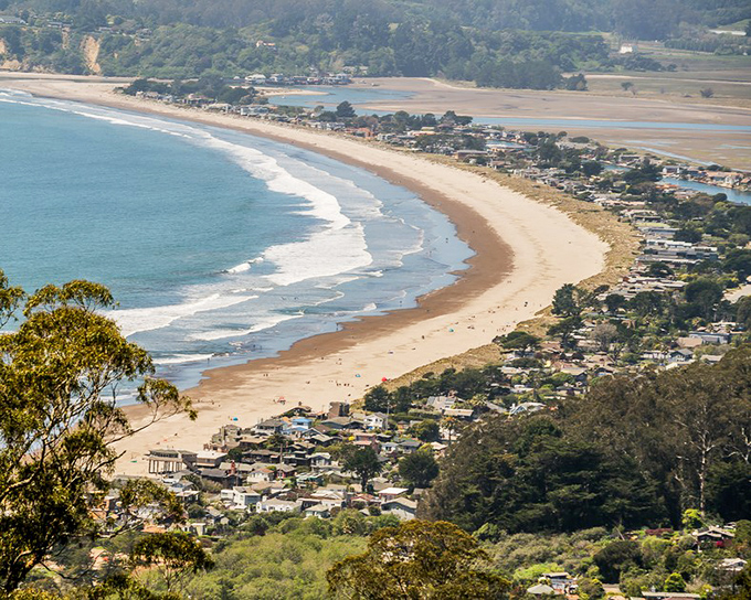 Stinson Beach stretches like nature's perfect smile along the California coast, with Mount Tam standing guard over this slice of paradise.