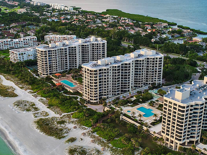 Paradise from above: where golf courses meet pristine beaches and the water shifts between emerald and sapphire like nature's mood ring.