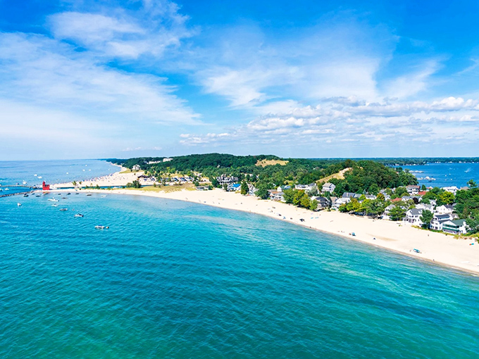 Big Red stands proud like a crimson sentinel guarding Lake Michigan's shores, proving lighthouses don't need height to make a statement.