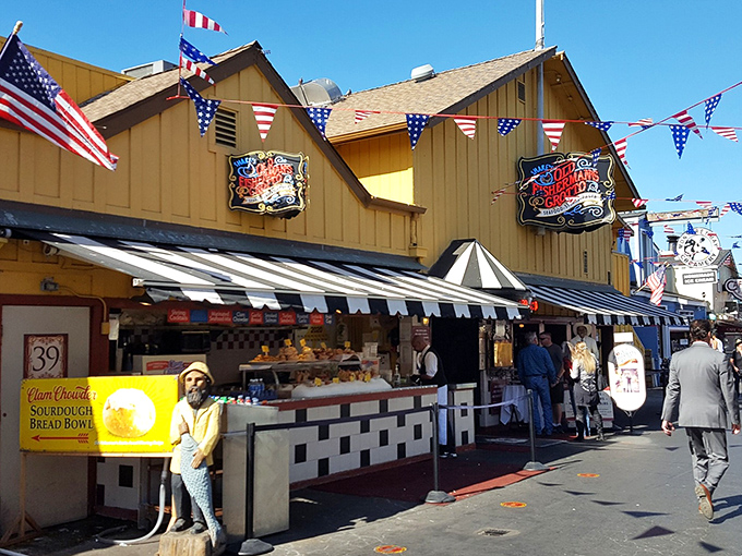 The iconic yellow exterior of Old Fisherman's Grotto stands like a beacon of culinary promise on Monterey's wharf, complete with patriotic bunting that screams "America's seafood lives here!"