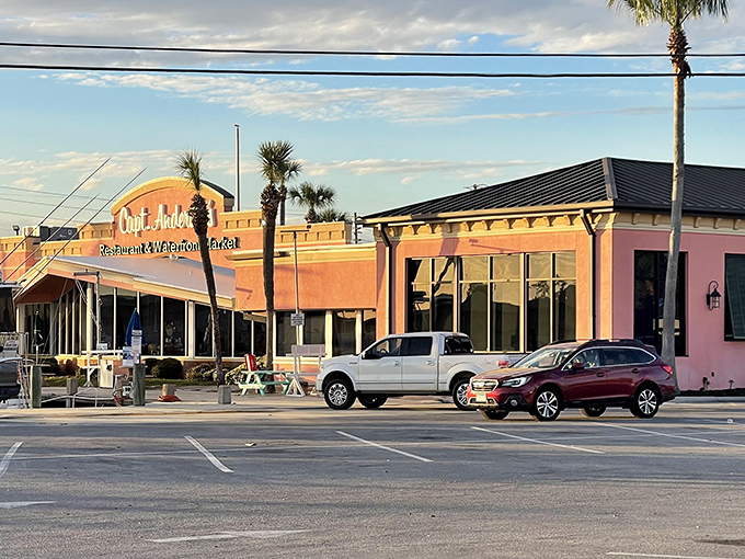 The iconic coral-pink exterior of Captain Anderson's stands like a delicious mirage against the Panama City Beach sky, beckoning seafood lovers from miles around.