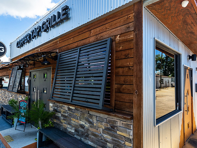 The rustic-meets-modern exterior of Copper Tap Grille beckons with its corrugated metal, warm wood, and stone accents&mdash;architectural proof that the best flavors often hide in unassuming packages.