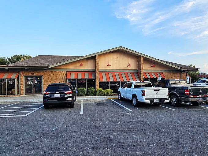 The unassuming brick exterior with its cheerful orange awnings promises what every great diner should: comfort food without pretension.