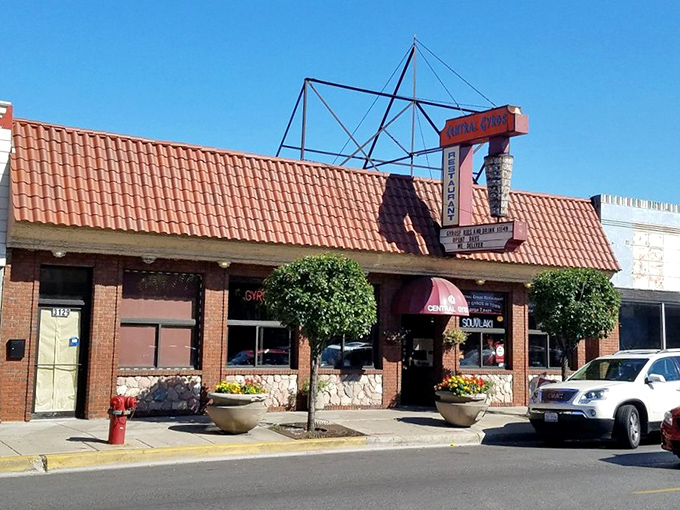 This charming brick facade with its distinctive red tile roof whispers promises of Mediterranean magic waiting inside.