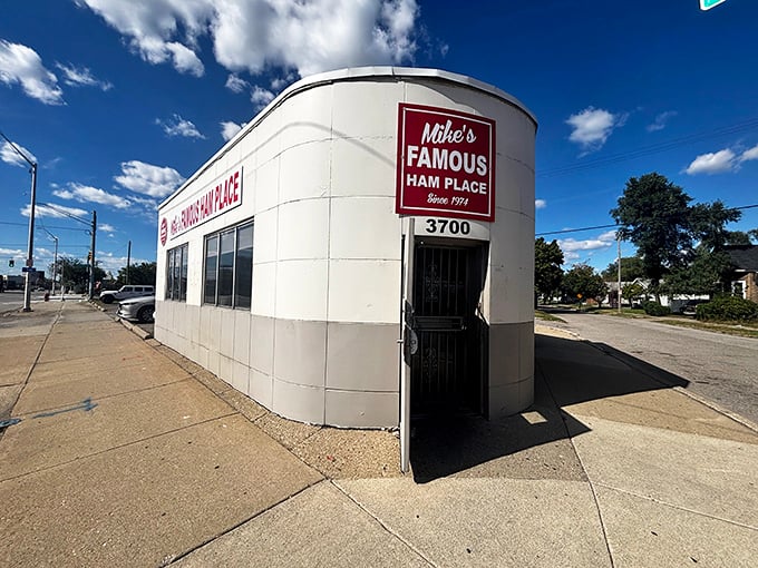 The unassuming white exterior of Mike's Famous Ham Place stands like a culinary lighthouse on Michigan Avenue, beckoning hungry travelers with its iconic red sign since 1974.