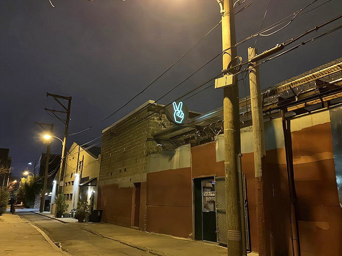 The unassuming entrance to Pizzeria Beddia feels like discovering a secret doorway to pizza paradise. Industrial-chic meets culinary magic.