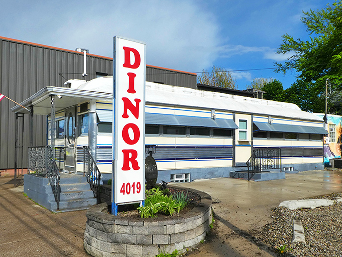 The iconic Park Dinor sign stands tall against the Erie sky, beckoning hungry travelers with its vintage charm and promise of classic American comfort food.