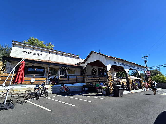 The white clapboard exterior of Dry Creek General Store stands like a time capsule in wine country, complete with "THE BAR" proudly displayed for weary travelers.