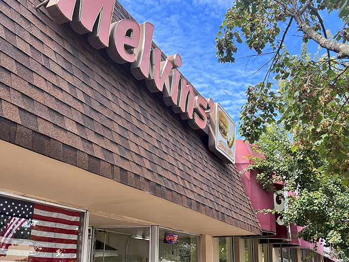 The iconic Melvin's storefront beckons hungry travelers with its vintage sign and simple promise: real food without the fuss. Small-town America at its most delicious.