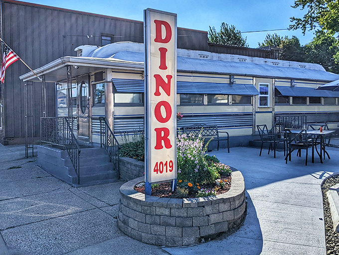 The classic railcar silhouette of Lawrence Park Dinor stands proudly on Main Street, its vintage sign promising comfort food salvation to hungry Erie residents. 