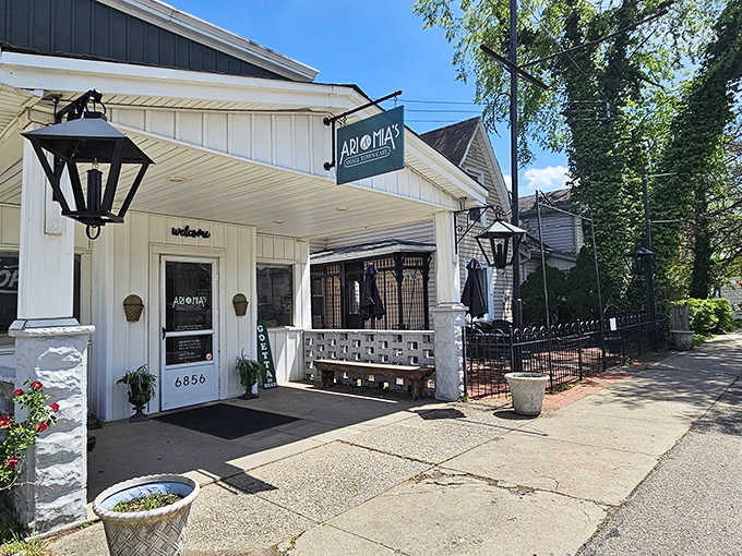 The charming exterior of Ari & Mia's beckons with its vintage lanterns and welcoming "GOETTA" sign&mdash;a true Ohio small-town treasure.