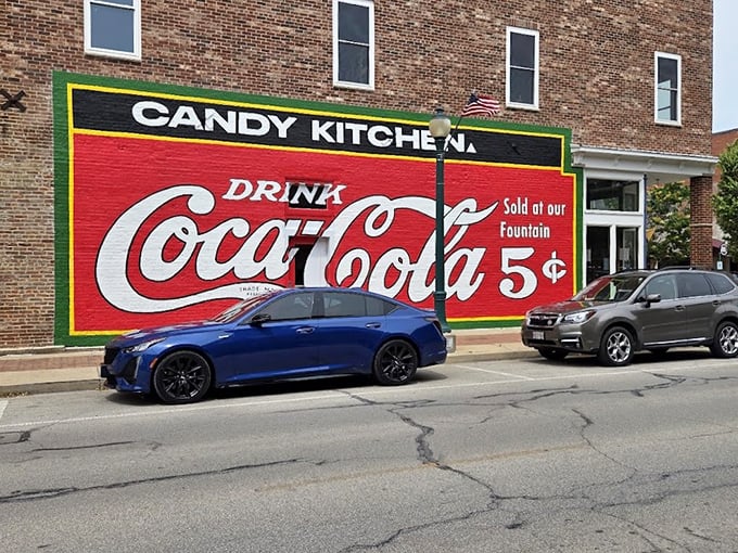 The historic brick façade of Flesor's Candy Kitchen stands as a time capsule in downtown Tuscola, complete with vintage Coca-Cola signage promising sweet nostalgia inside.