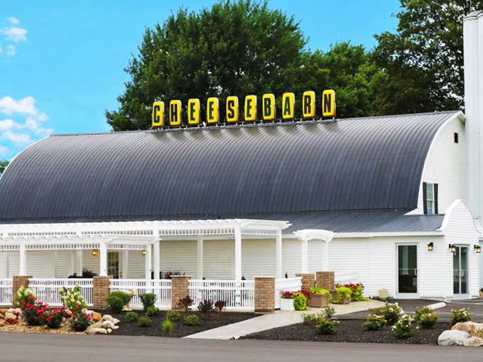 The iconic barrel-roofed Grandpa's Cheesebarn stands like a dairy cathedral just off I-71, promising roadtrippers salvation from mediocre snacks.