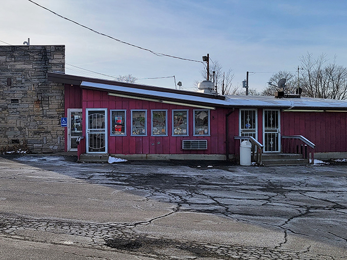 The stone facade and bright red exterior of Porky's stands like a culinary time capsule, preserving flavors that chain restaurants can only dream of replicating.