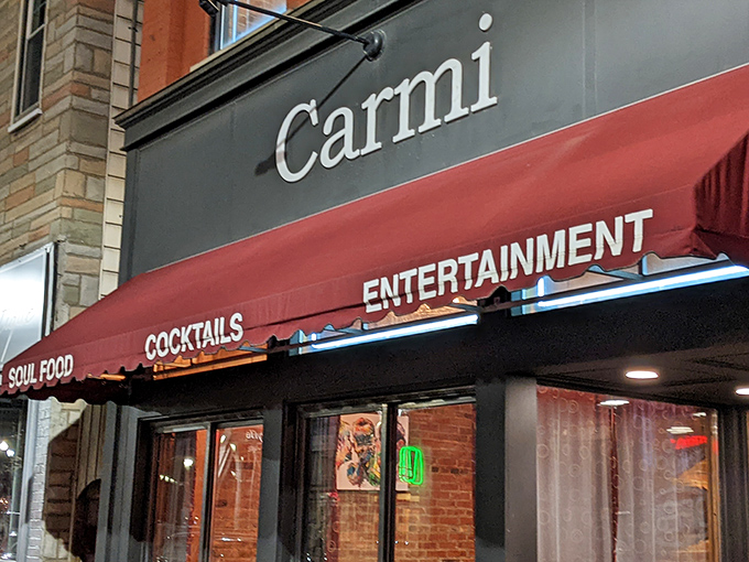 The unassuming brick facade of Carmi Soul Food beckons with a simple promise on its red awning: soul-satisfying Southern cuisine awaits inside.
