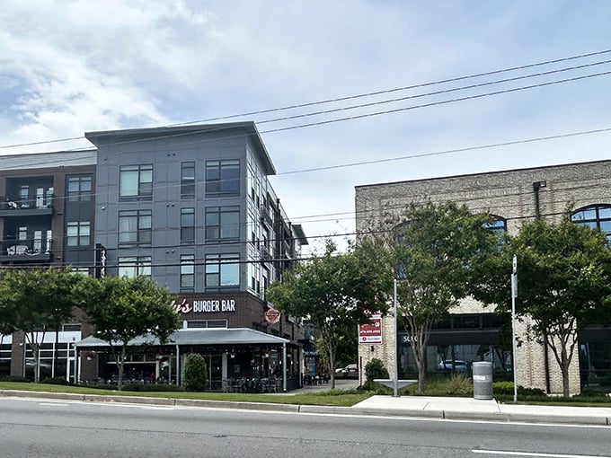 Bad Daddy's modern brick exterior beckons burger lovers with its inviting patio seating and string lights&mdash;urban comfort food paradise in Chamblee's evolving landscape.